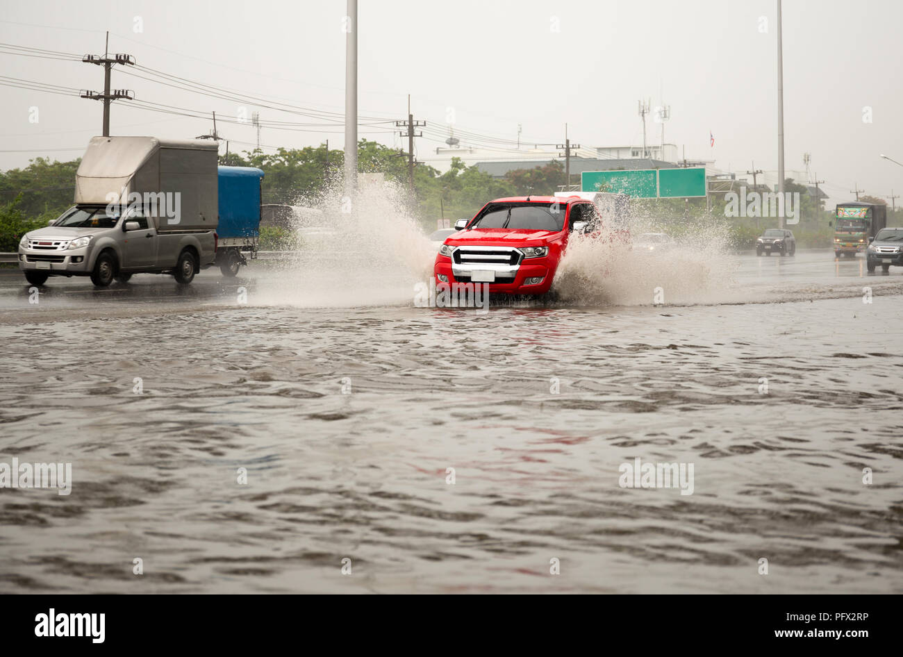 Car driving through flood water on the road Stock Photo - Alamy