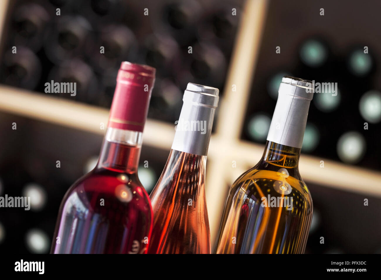 Three wine bottles in a tasting room Stock Photo - Alamy