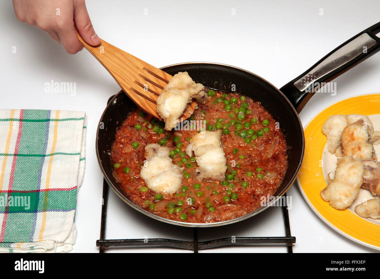 Monkfish with peas. Step by step. Prepared dish: BK6JKJ Stock Photo - Alamy