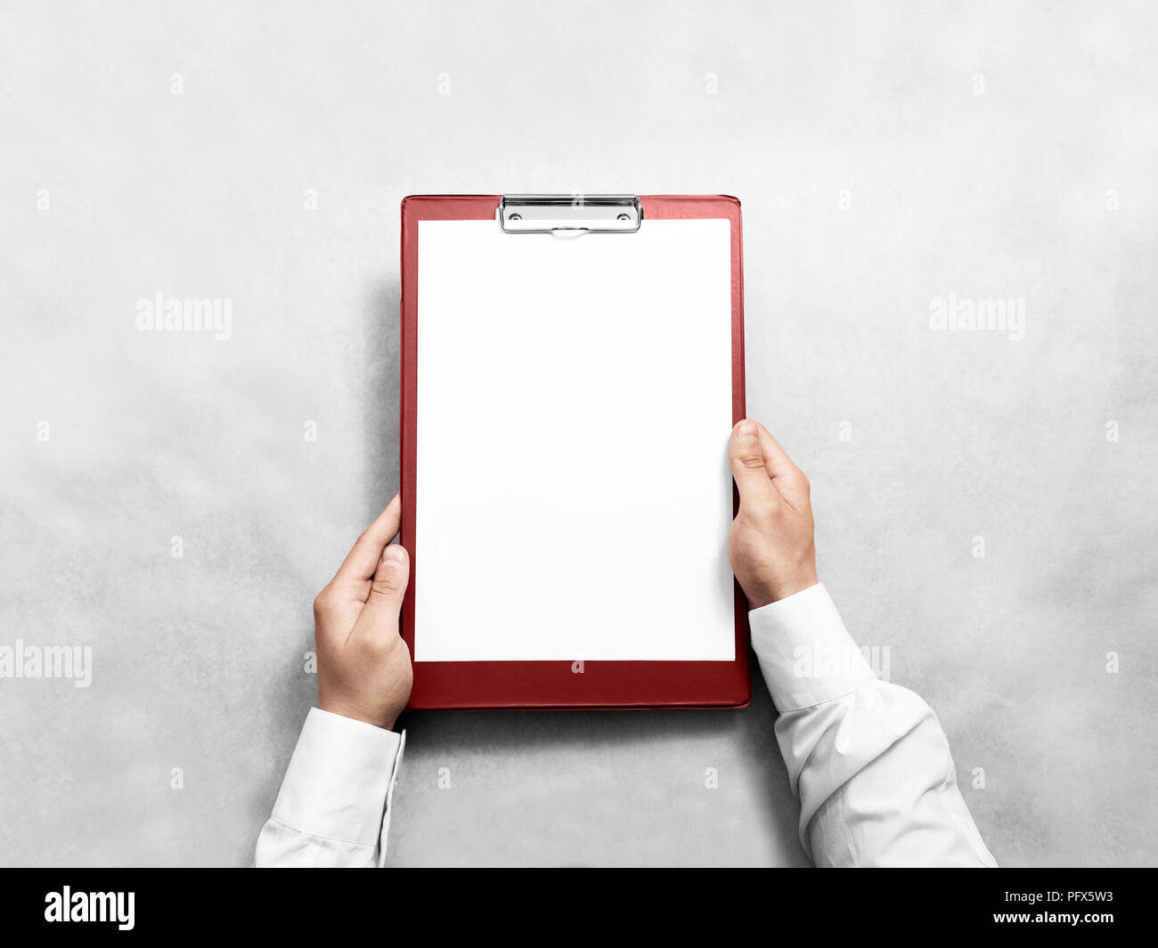 Hand holding blank red clipboard with white paper design mockup. Clear ...