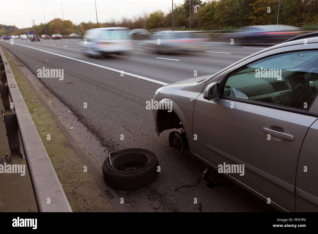 Car with flat tire stopped on hard shoulder of motorway Stock Photo - Alamy