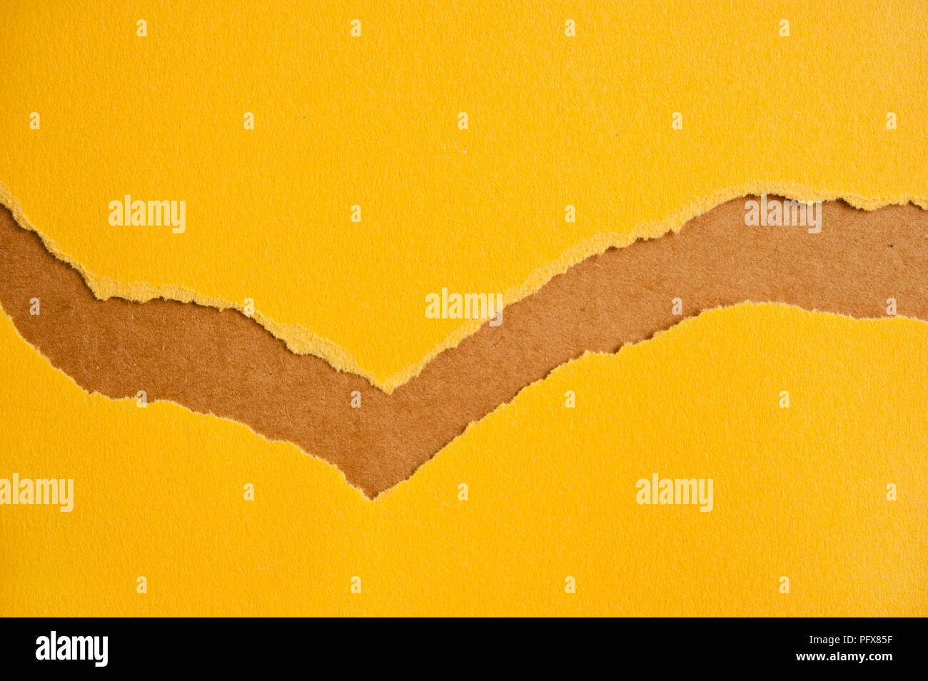 yellow paper that has been ripped in half Stock Photo - Alamy