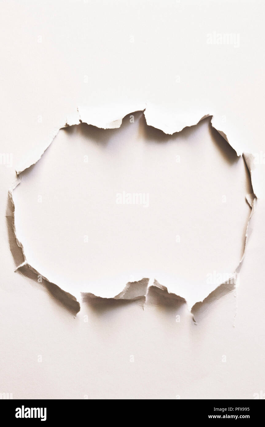 white paper teared apart in the center Stock Photo - Alamy