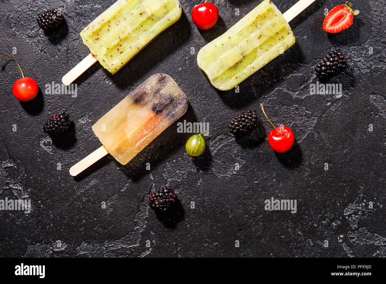 Photo on top of frozen fruit ice on sticks and berries Stock Photo - Alamy