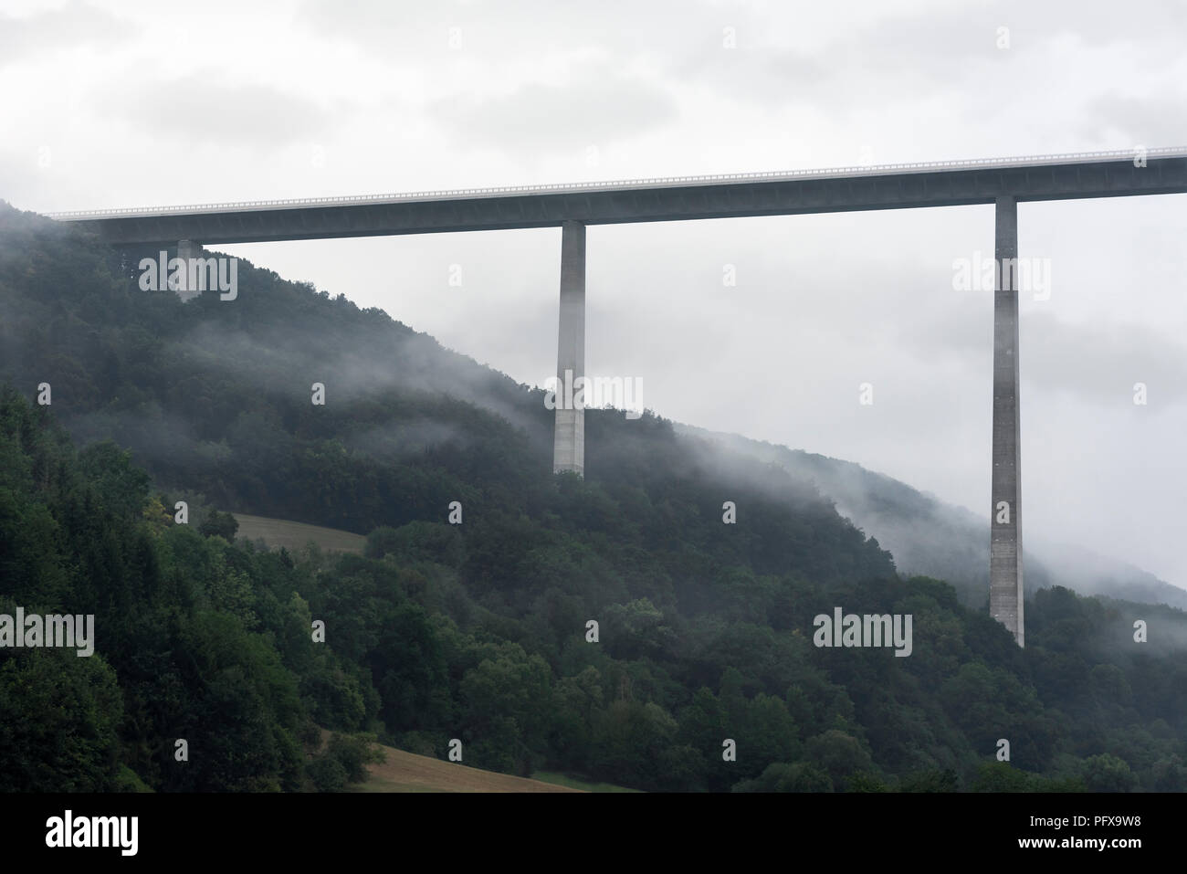 Gloomy landscape with wooded hills and the highest viaduct in Germany ...