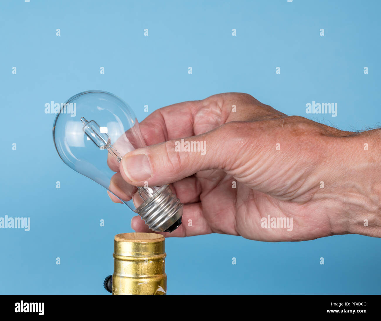 Hand unscrewing lightbulb hi-res stock photography and images - Alamy