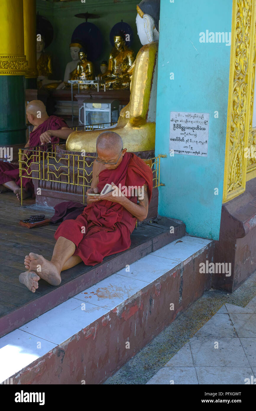 Monk surfing mobile phone, Shwedagon Pagoda, Yangon, Myanmar Stock ...