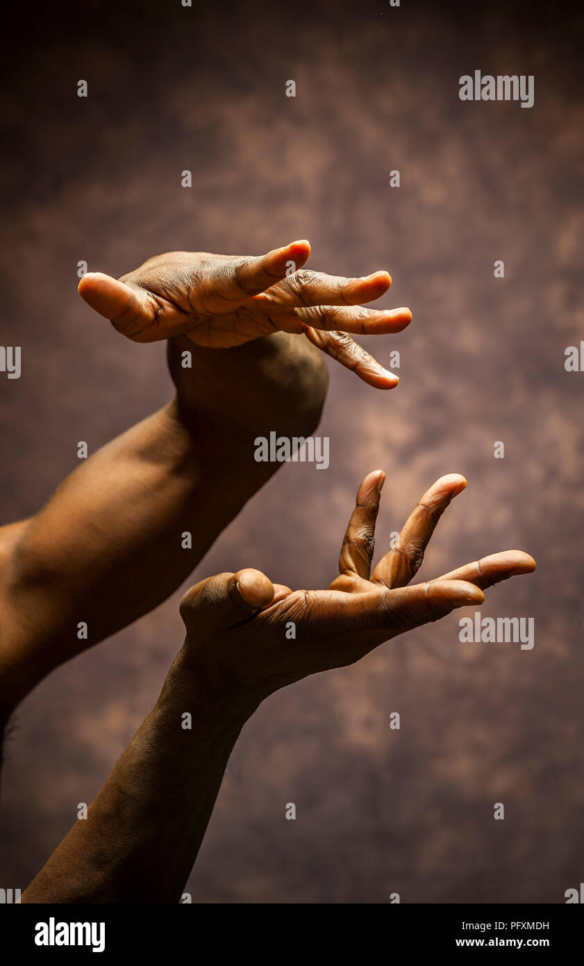 A pair of African American / black hands and arms in various positions ...