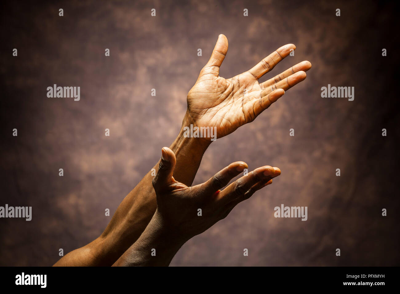 A pair of African American / black hands and arms in various positions ...