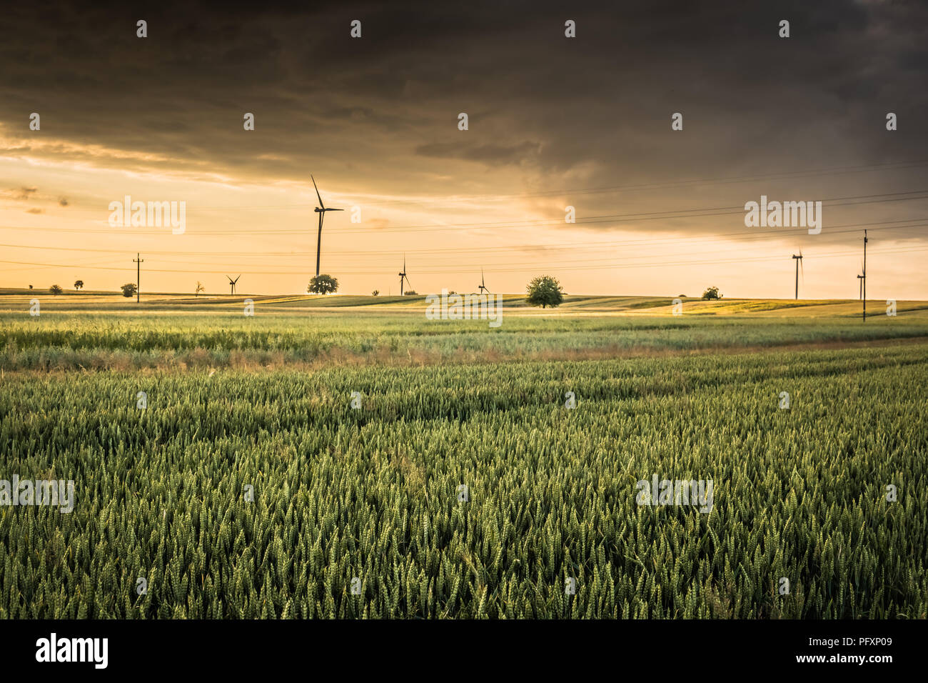 dark clouds are coming over fields and wind turbine Stock Photo - Alamy