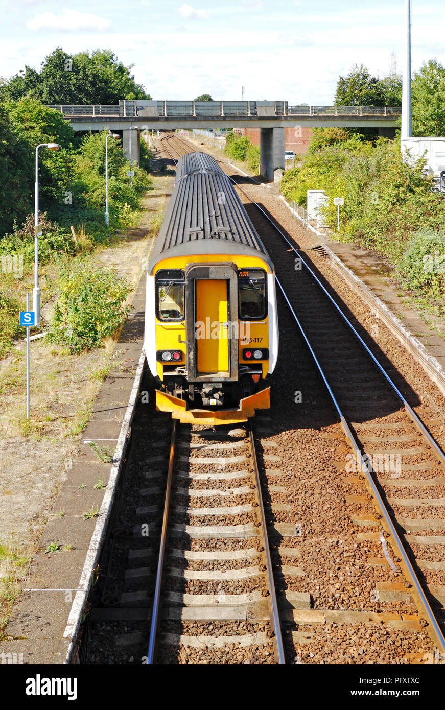 A diesel multiple unit train departing the railway station at Acle ...