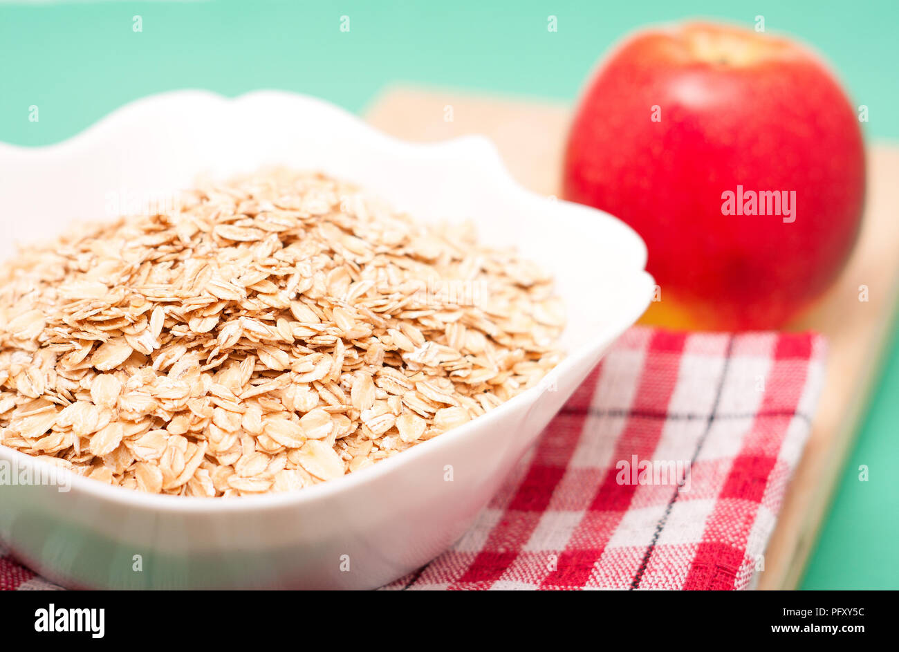apple with oat flakes in bowl Stock Photo - Alamy