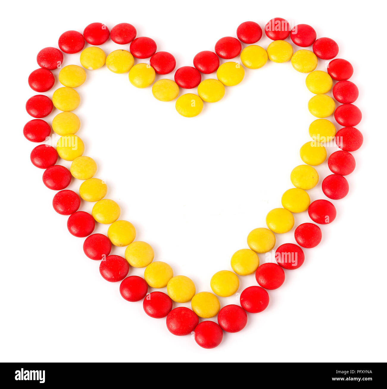 Heart made of red colored sweets round Stock Photo - Alamy