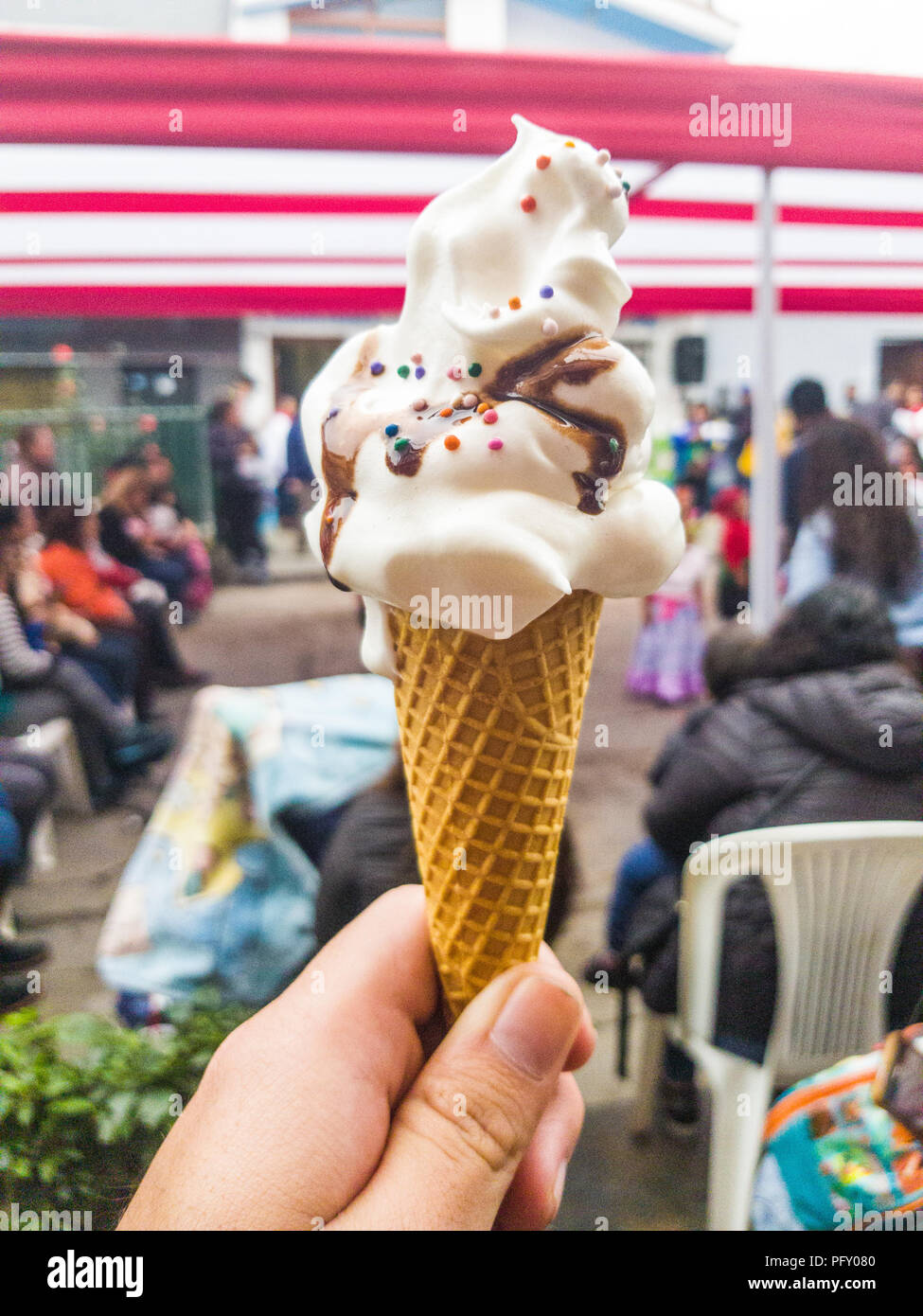 Vanilla ice cream with chocolate and caramel sparks, on street market ...