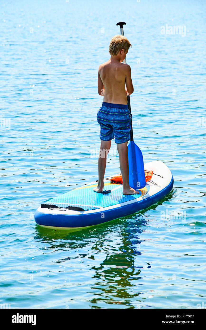 Boy paddle boarder hi-res stock photography and images - Alamy