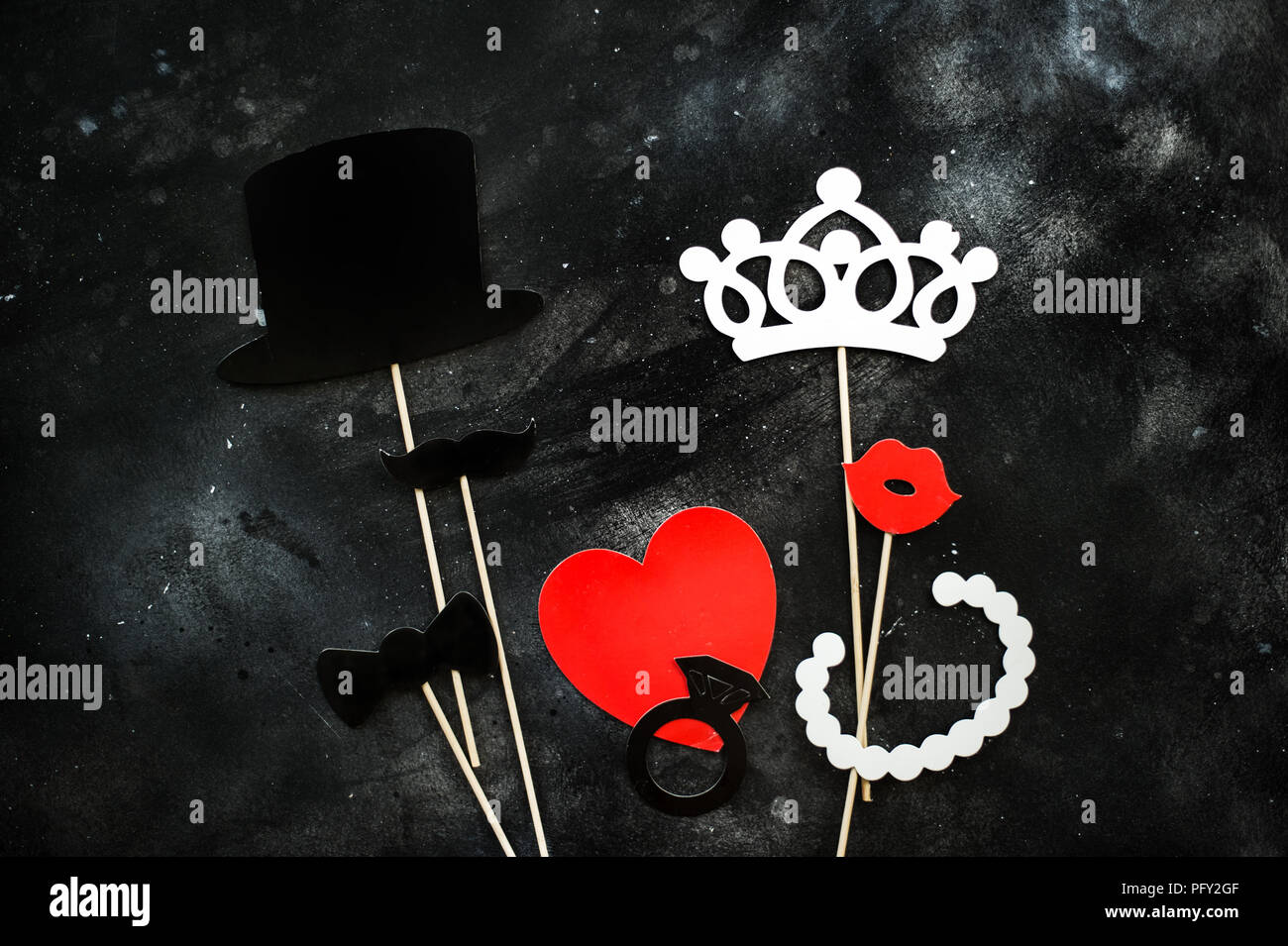 Photo booth props mustache, crown, lips on black board background ...