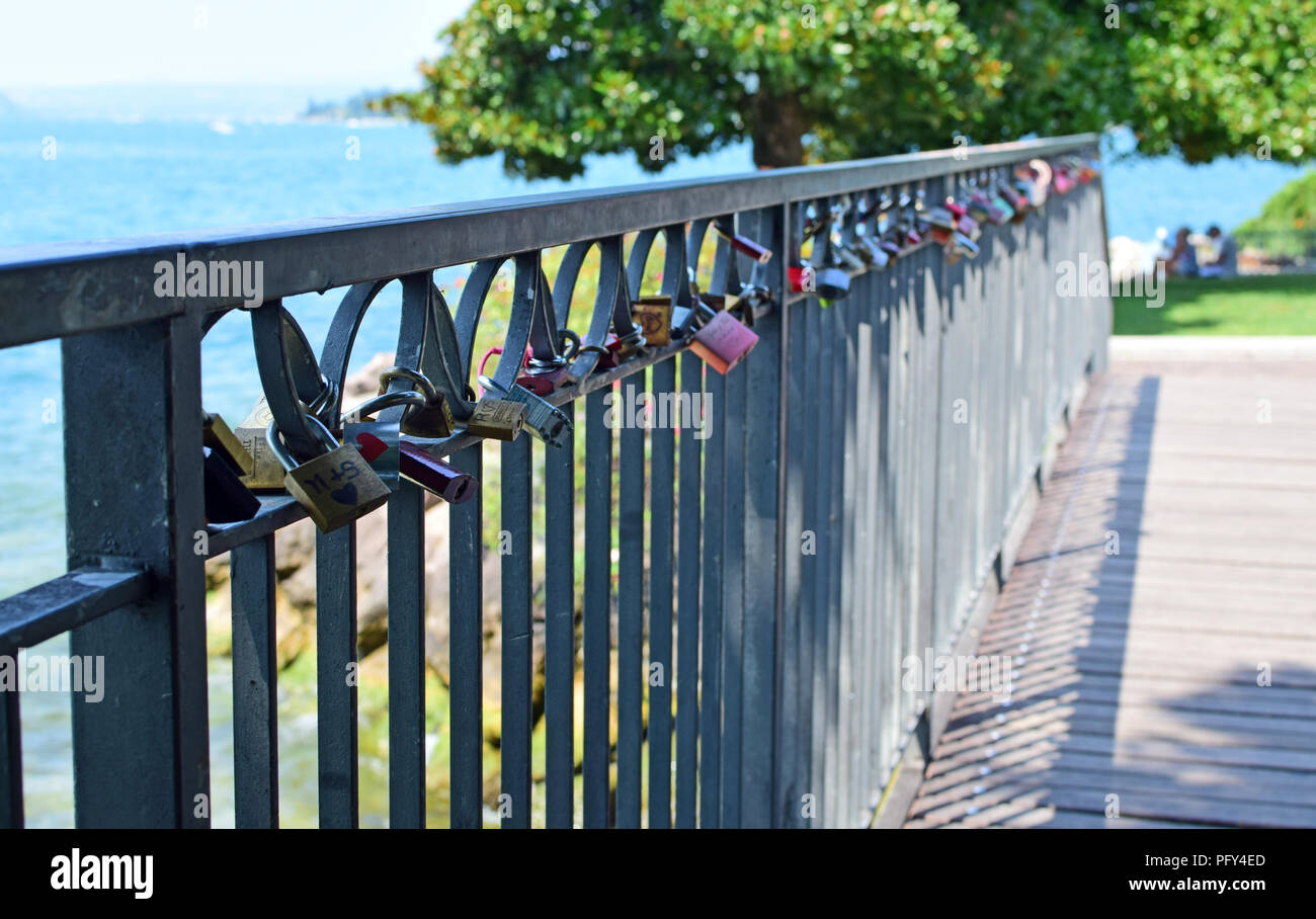 Love locks on a bridge at the waterfront in Lake Garda, Italy Stock ...