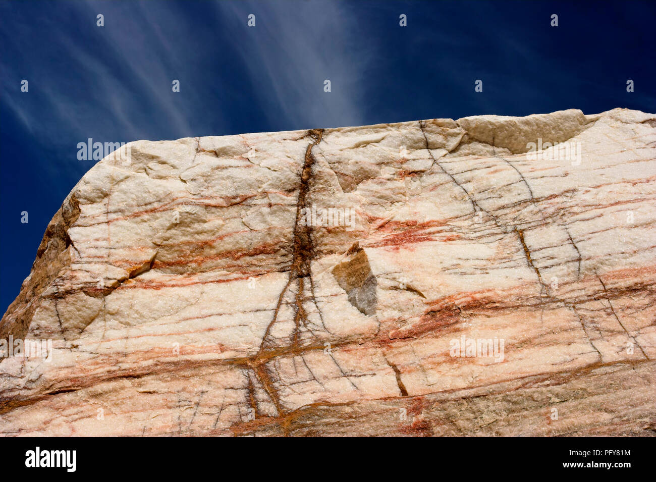 Huge block of raw marble against deep blue sky in a quarry in Estremoz ...
