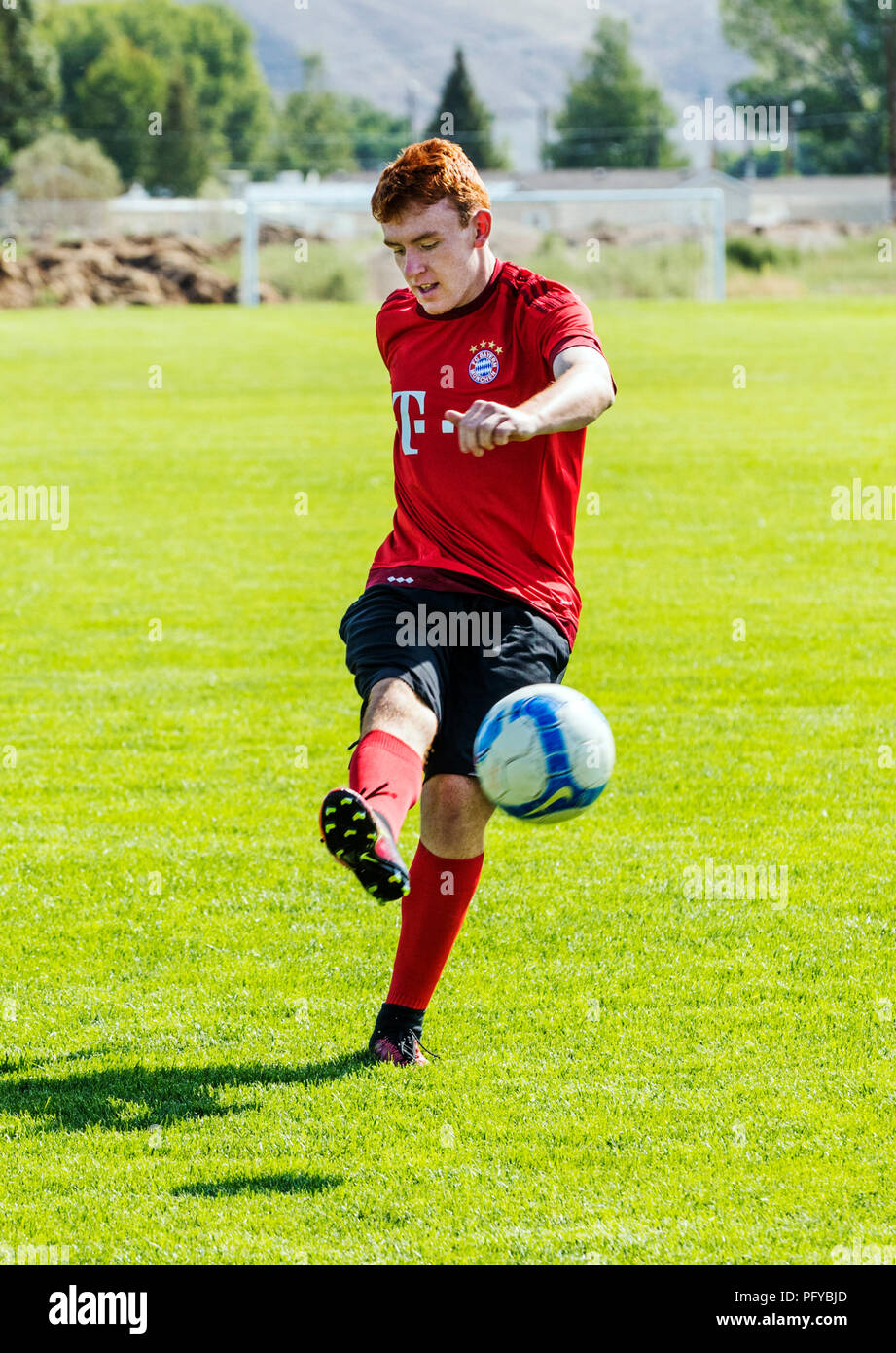 Football boot kicking ball boy hi-res stock photography and images - Alamy