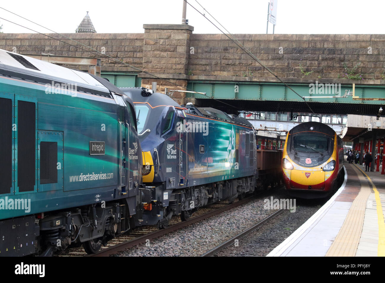 Pendolino electric train arriving at Lancaster station on WCML passing ...
