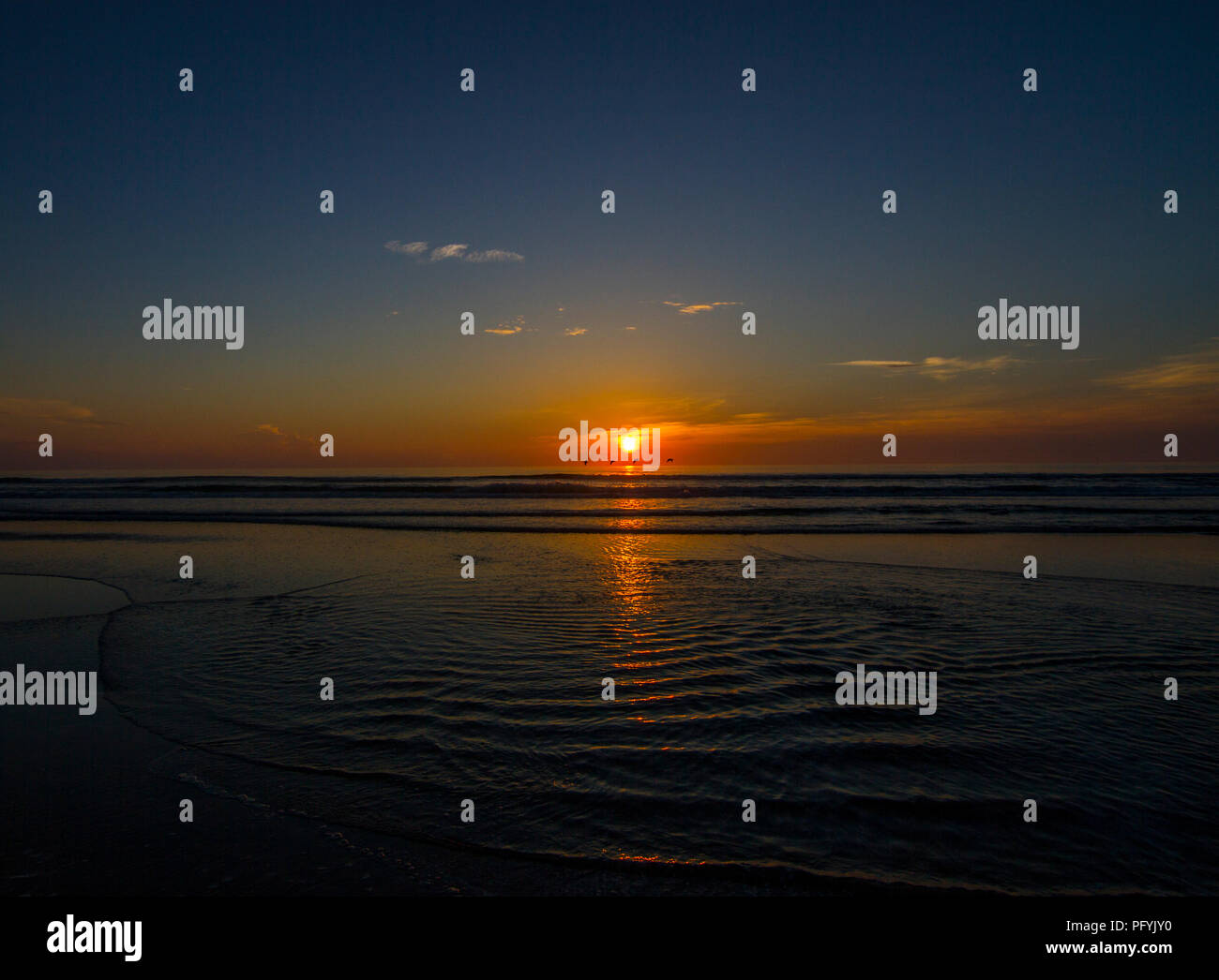Calm waters sunrise Stock Photo - Alamy