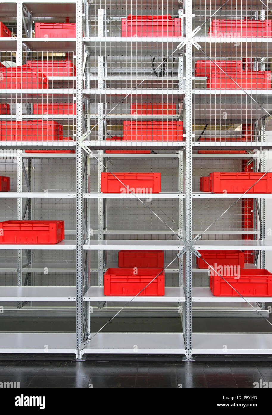 Red plastic crates at shelf in distribution warehouse Stock Photo - Alamy