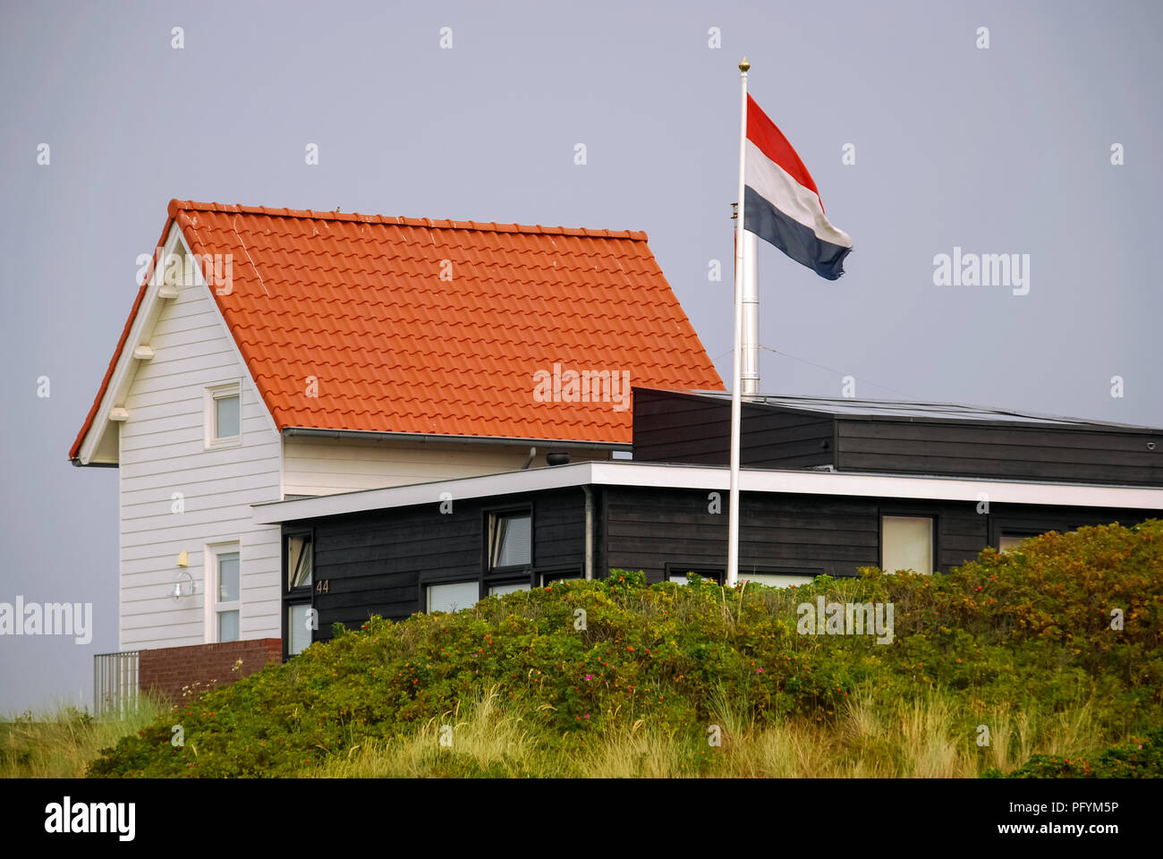 A white house and the Dutch flag on the Frisian Island of Vlieland, The ...