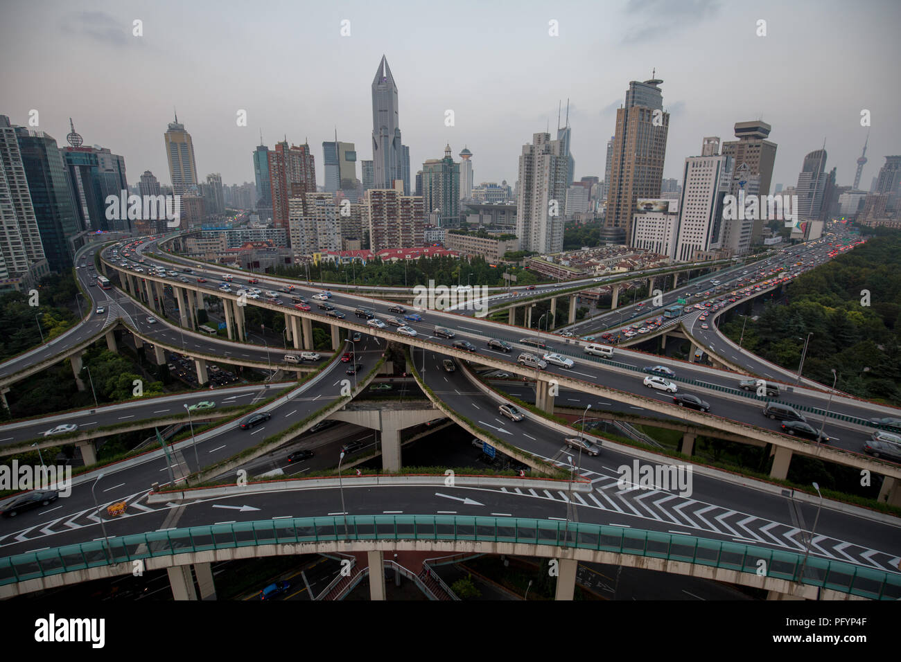 a city in asia with traffic and a river between skyscrapers Stock Photo ...