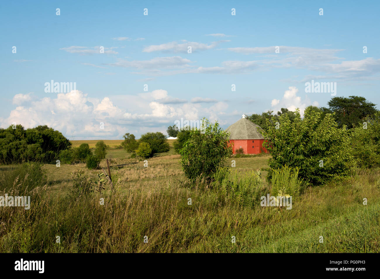 Unique round red barn surrounded by open farmland in rural illinois ...
