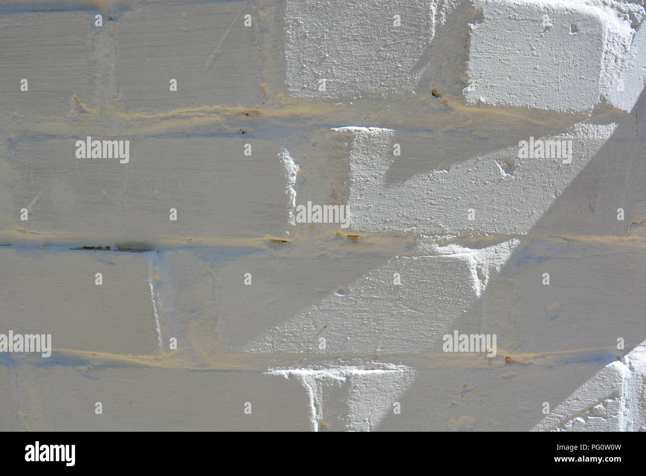 White brick building masonry painted white and light Stock Photo - Alamy