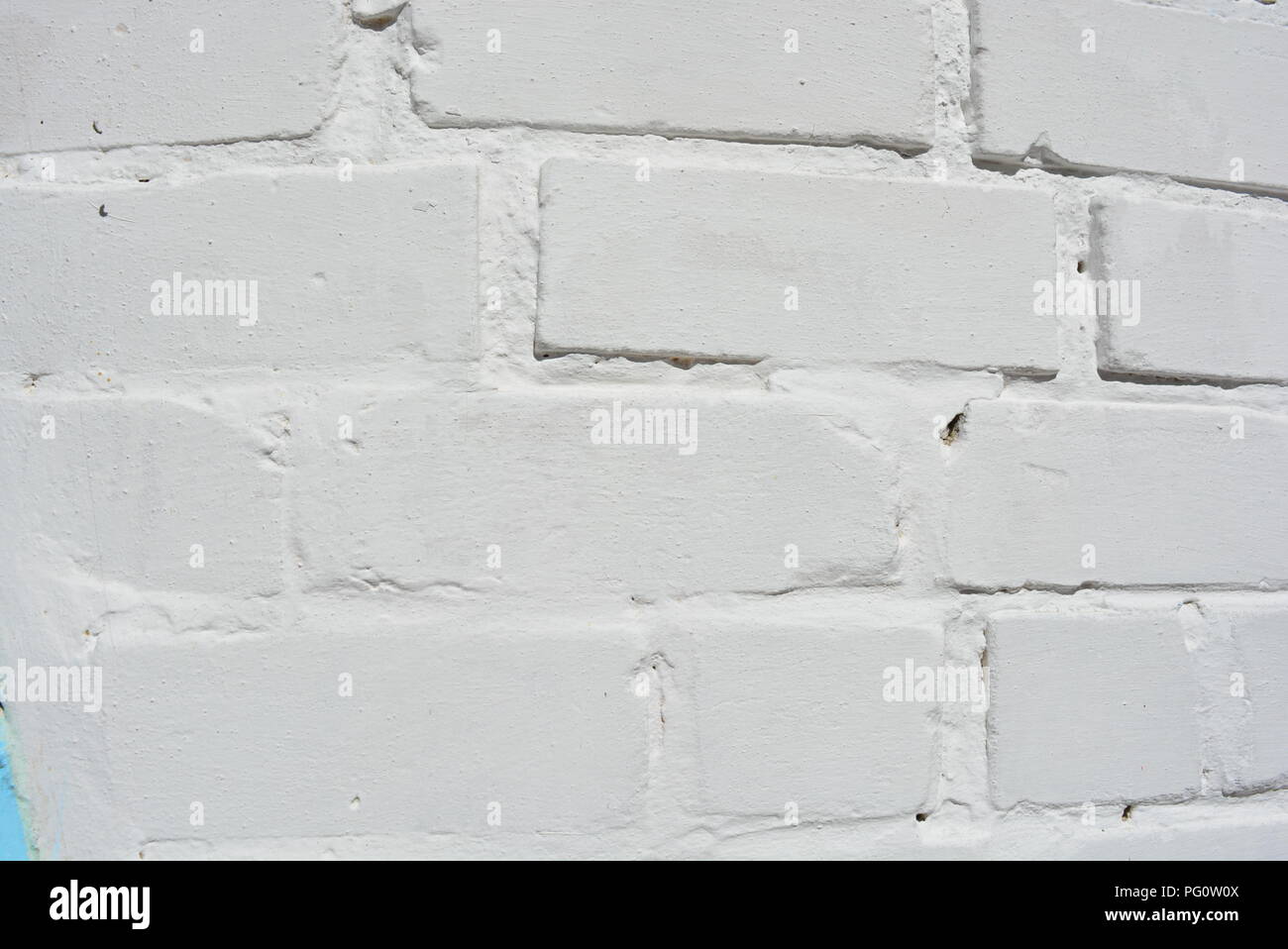 White brick building masonry painted white and light Stock Photo - Alamy