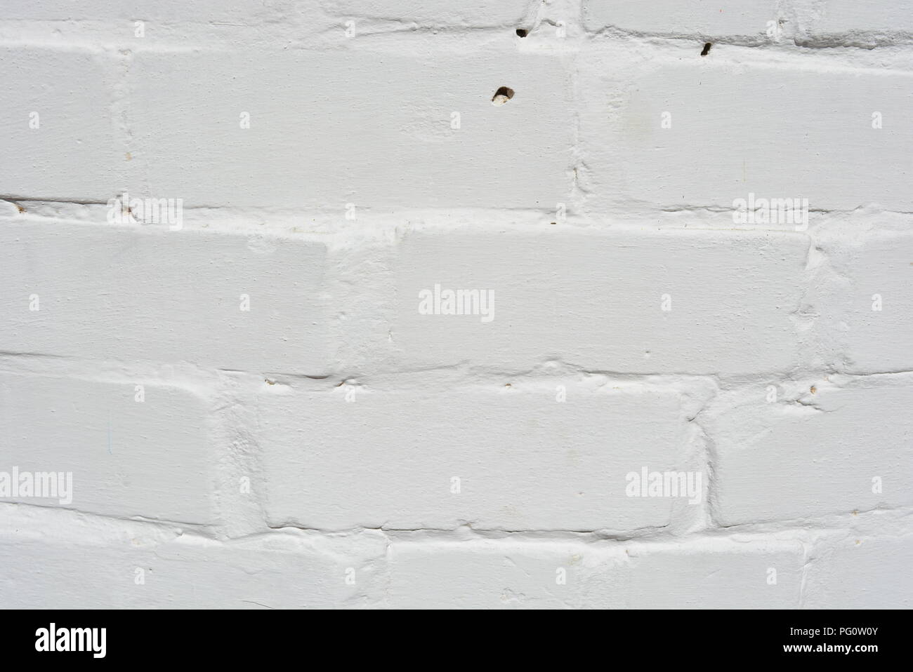 White brick building masonry painted white and light Stock Photo - Alamy