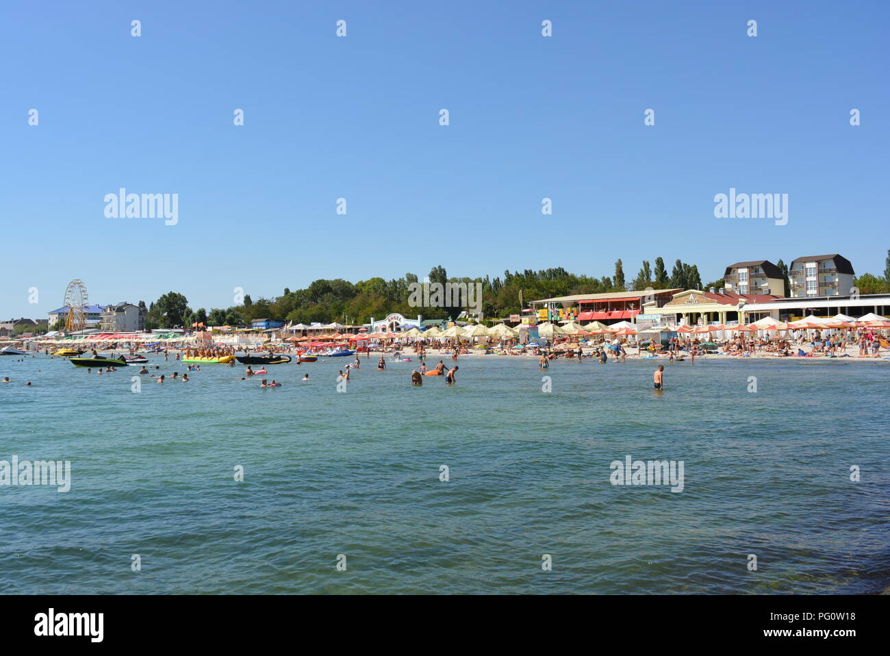 A beautiful gentle blue sky with tourists on the beach of the Black Sea ...