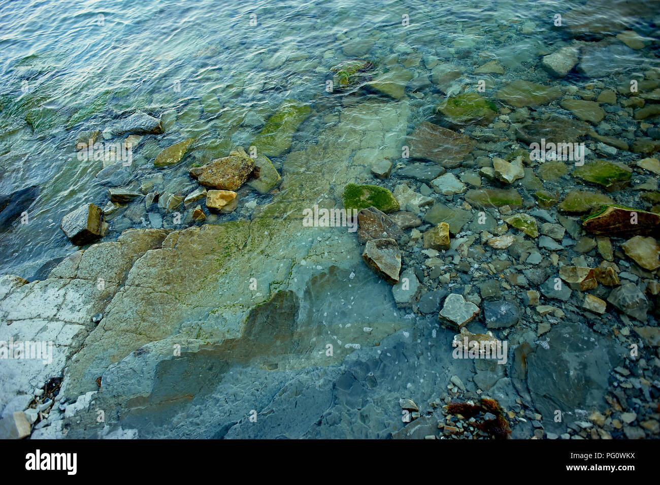 The texture or pattern of the stones under water. Rocky, rocky seashore ...