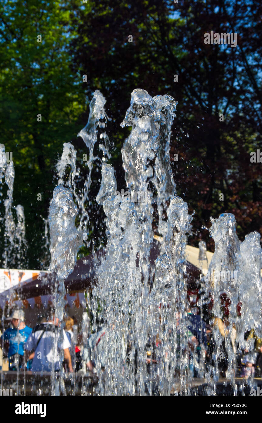 Fountain in city park on hot summer day, beautiful bright streams of ...