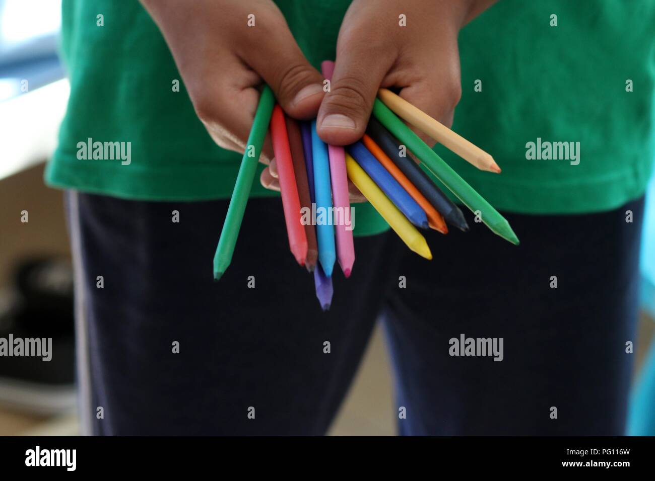 A boy holding colored pencils Stock Photo - Alamy