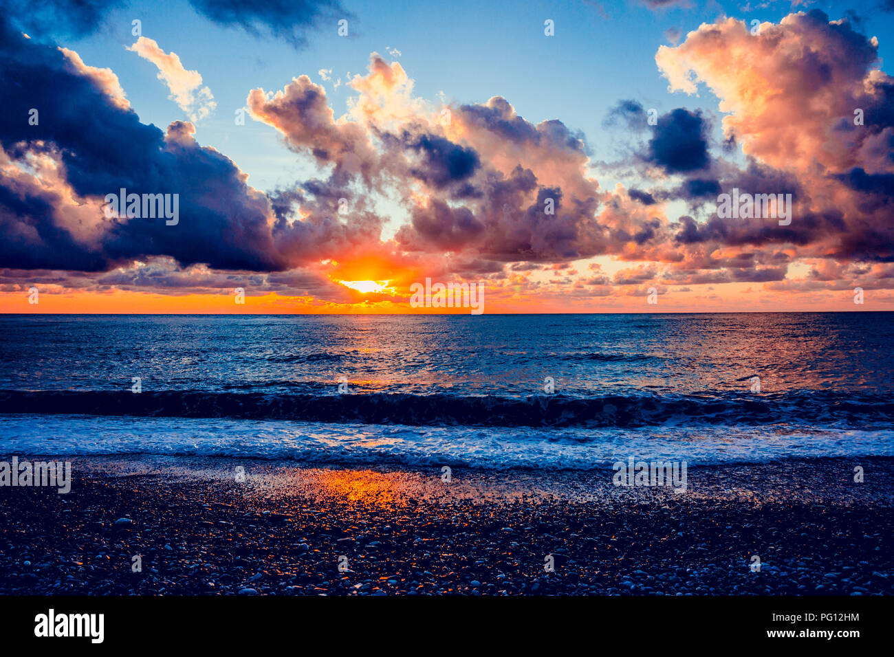 Colorful sunset over ocean Stock Photo - Alamy