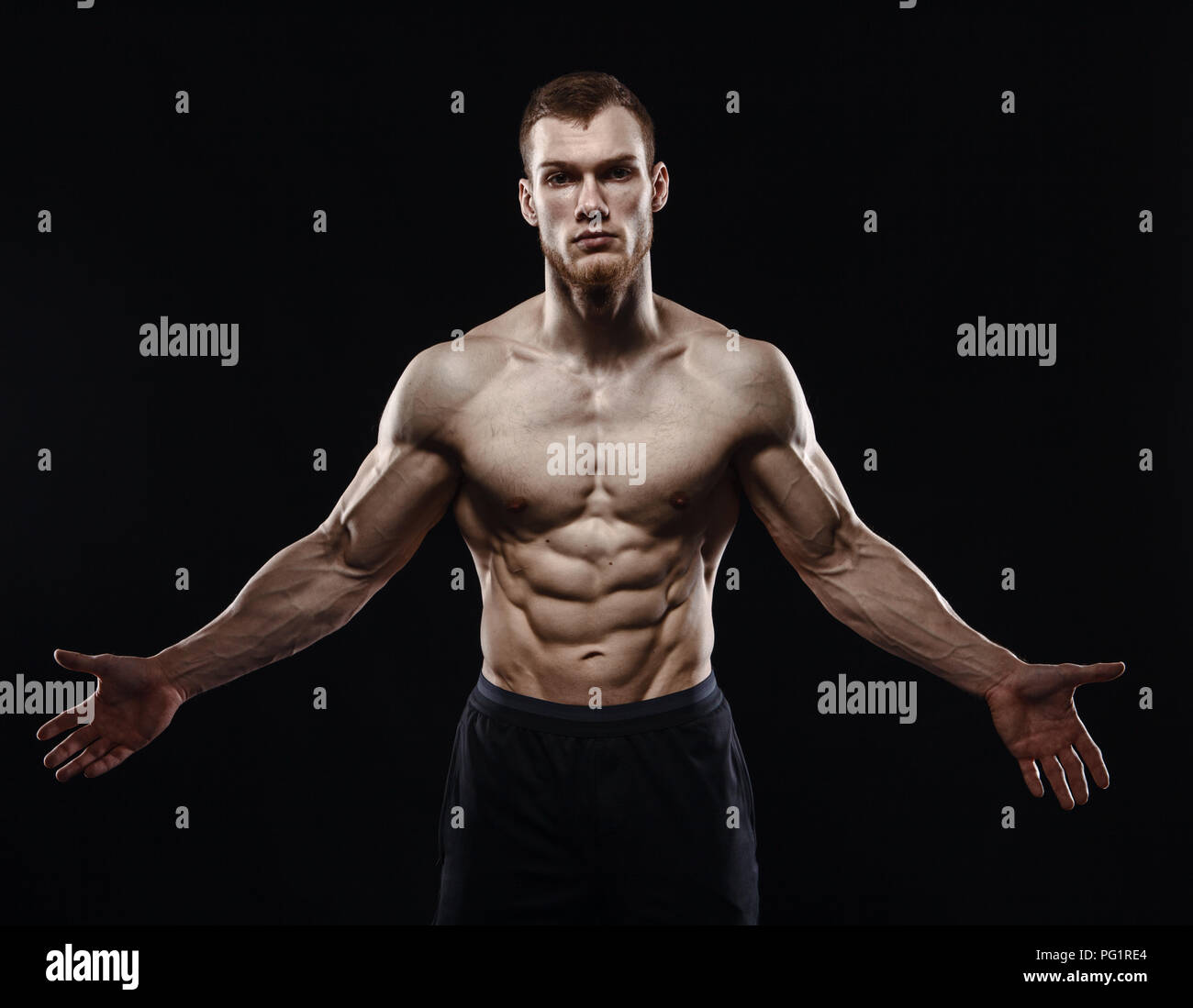 Aggressive man is a fighter, a bodybuilder on a black Stock Photo - Alamy