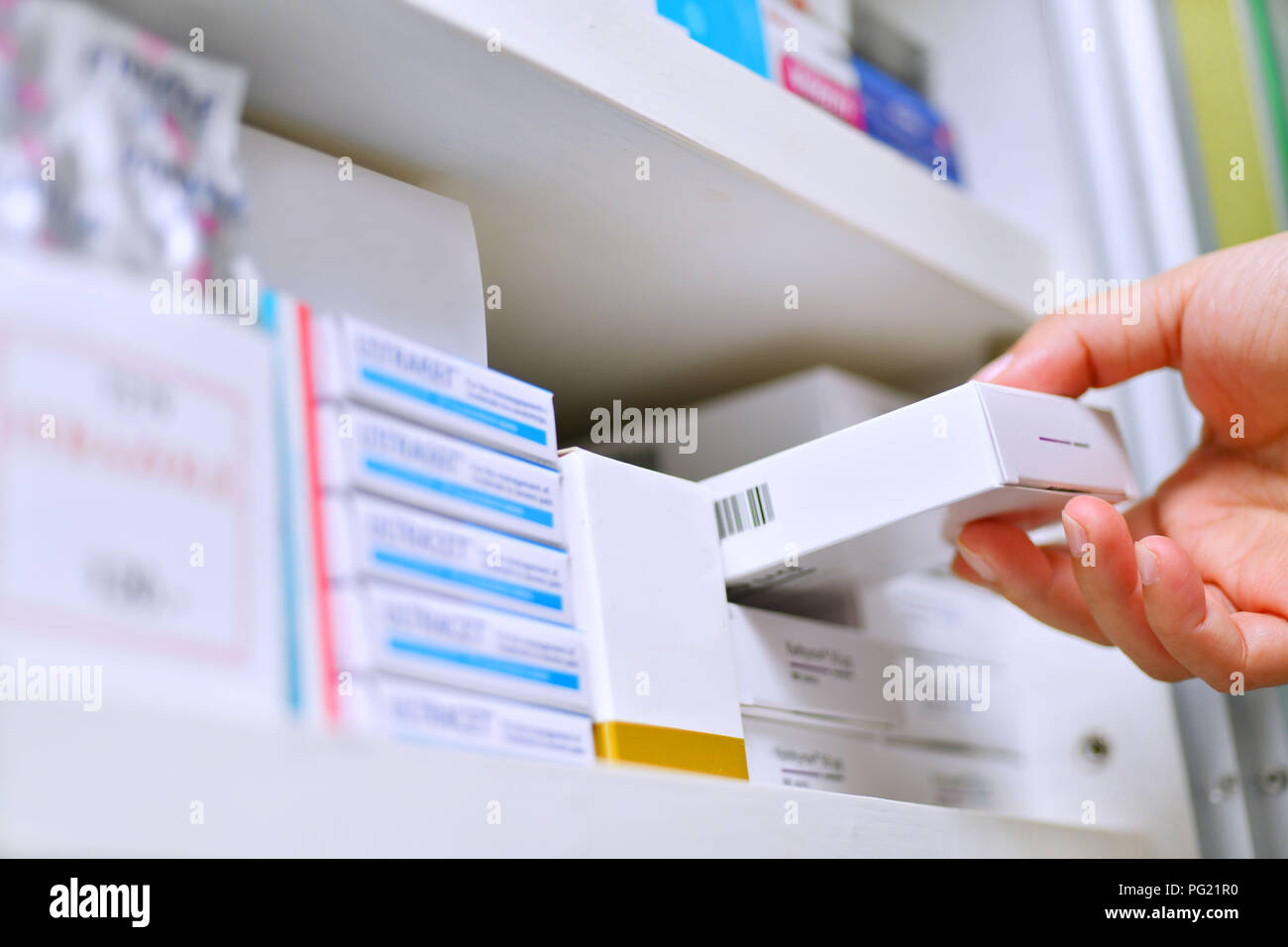 Closeup pharmacist hand holding medicine box in pharmacy drugstore ...