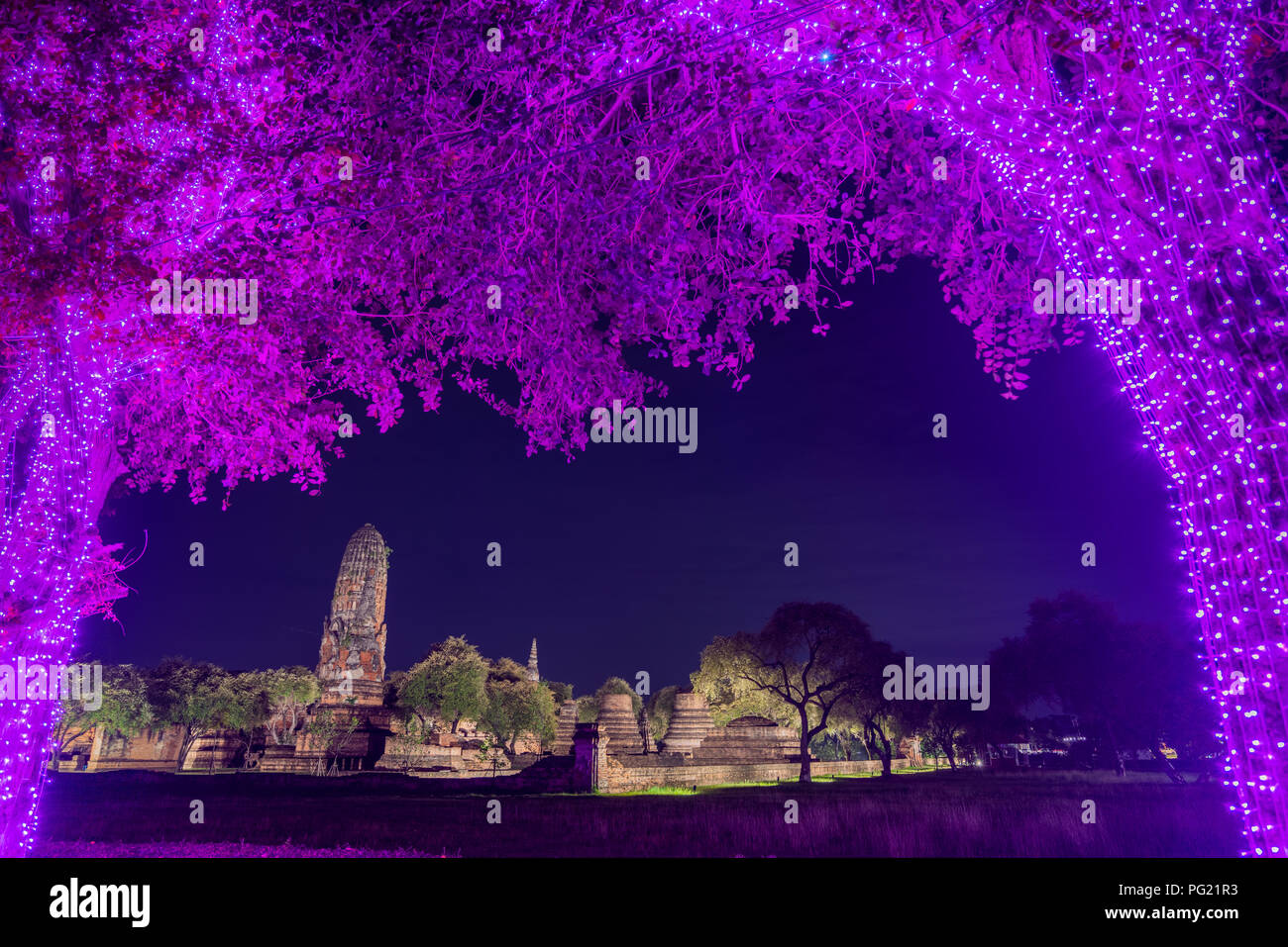 Ruined Buddhist temple in night scene with purple LED light decorated ...
