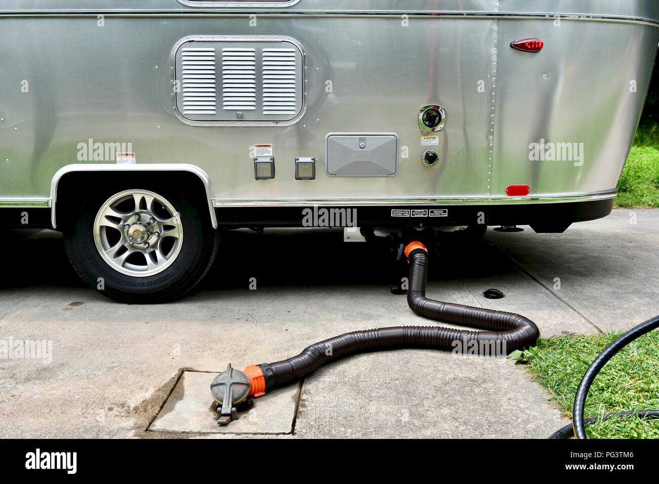 Airstream travel trailer emptying grey tank at dump station Stock Photo ...