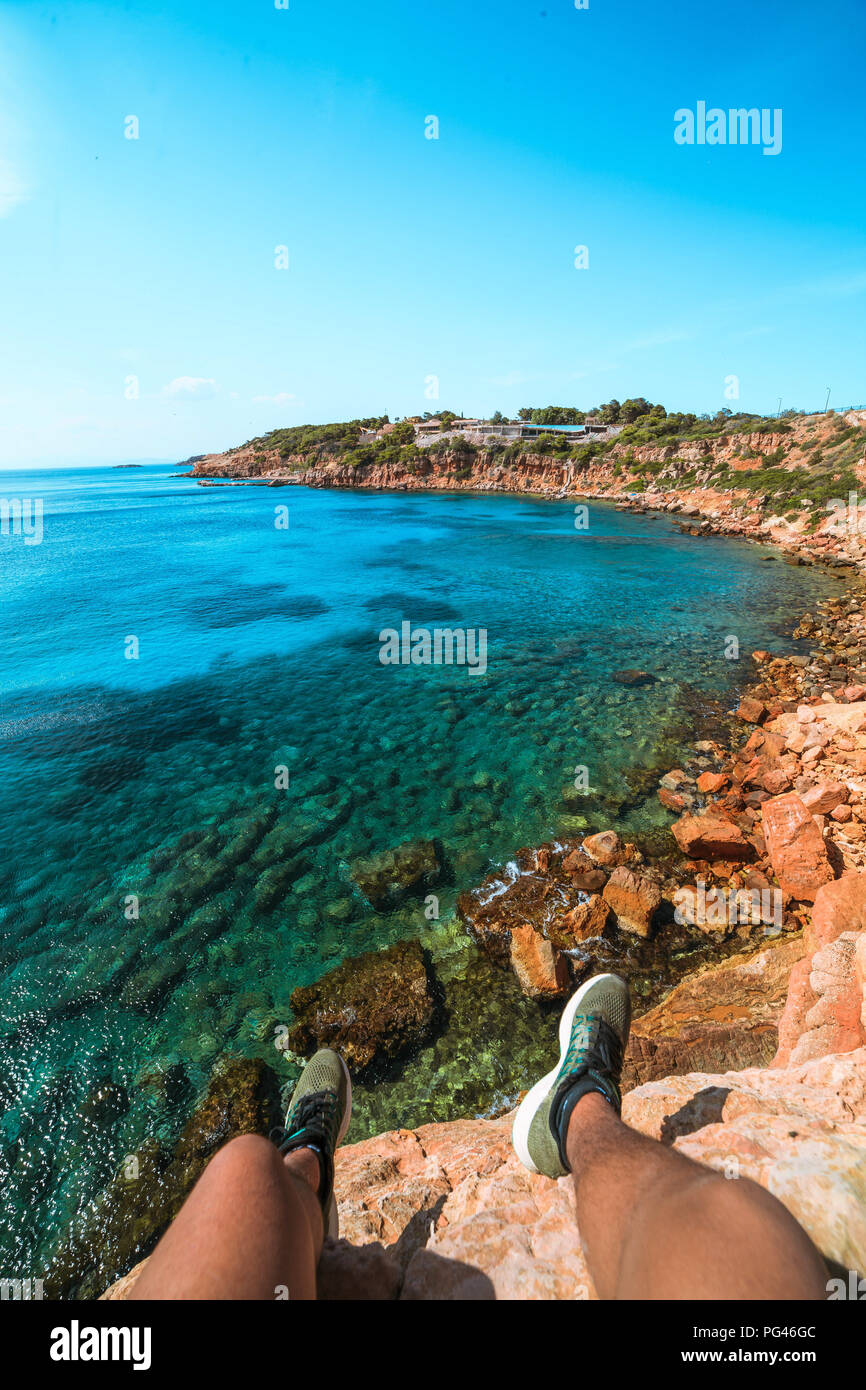 Hanging legs over Cliff in Greece, Bluewater summer adventure Stock ...
