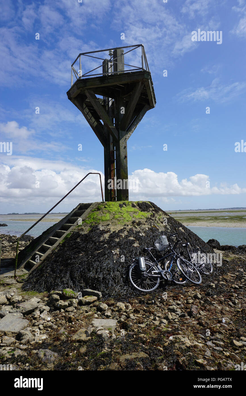 Old stone watching tower for high tide rising on the Atlantic ocean at ...