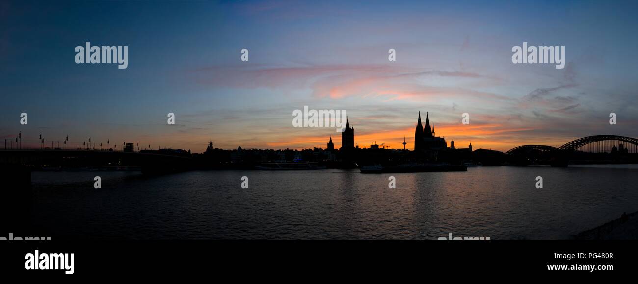 Panorama of Cologne skyline silhouette at sunset with colorful blue and ...