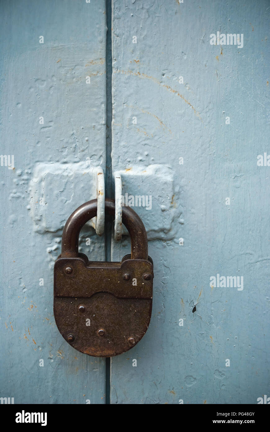 old rusted lock on a blue gate Stock Photo - Alamy