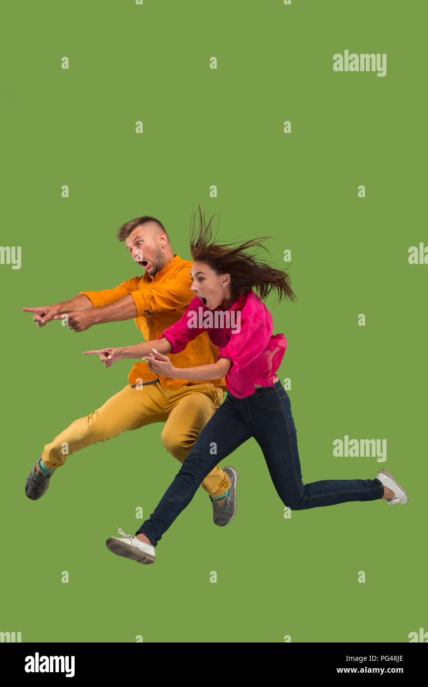 Freedom in moving and forward motion. The happy young couple jumping ...