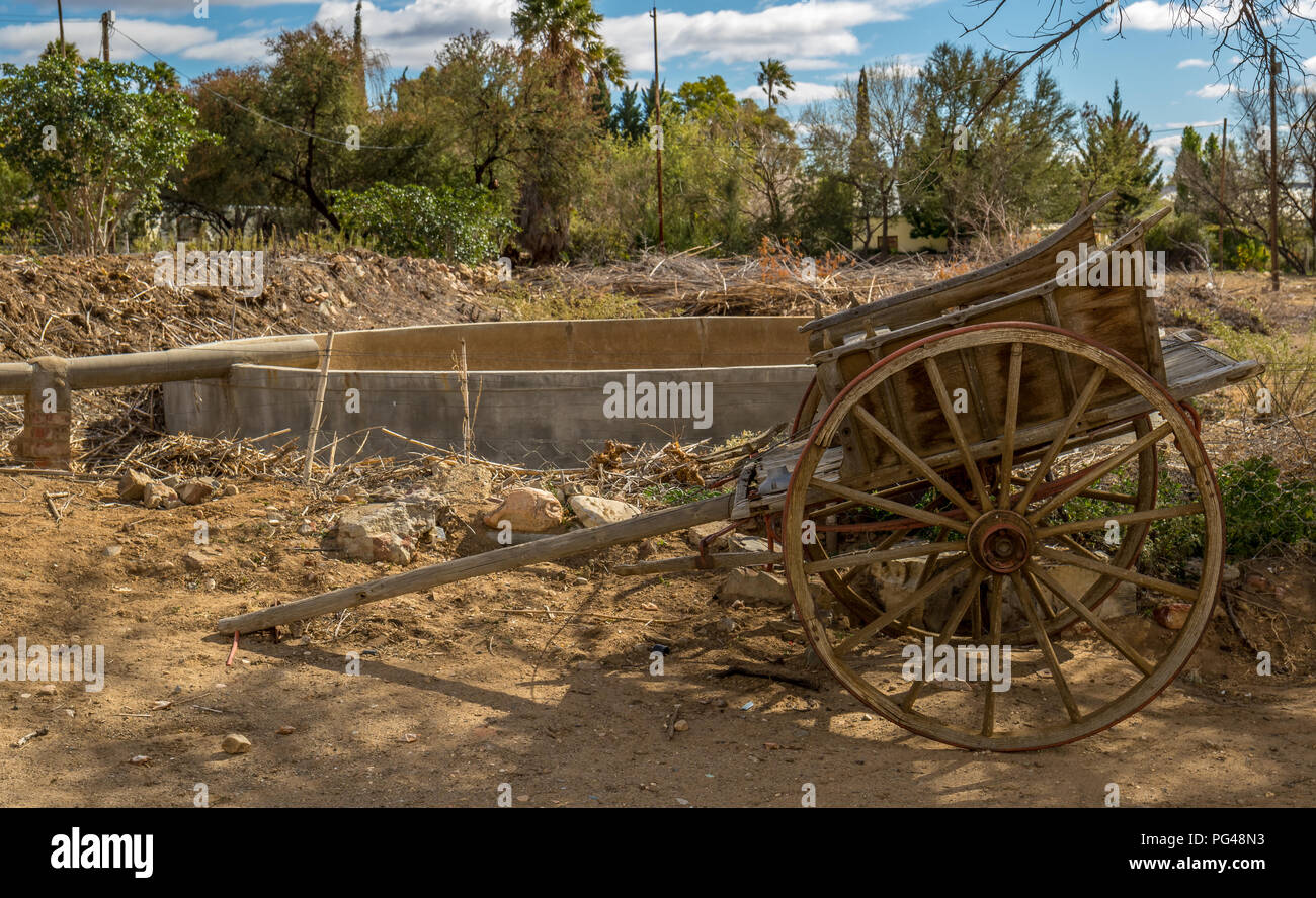 Weathered vintage wooden wagon exposed to the elements in a farmyard ...