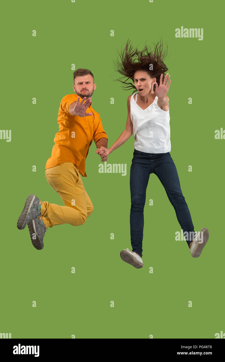 Freedom in moving and forward motion. The young couple jumping and ...
