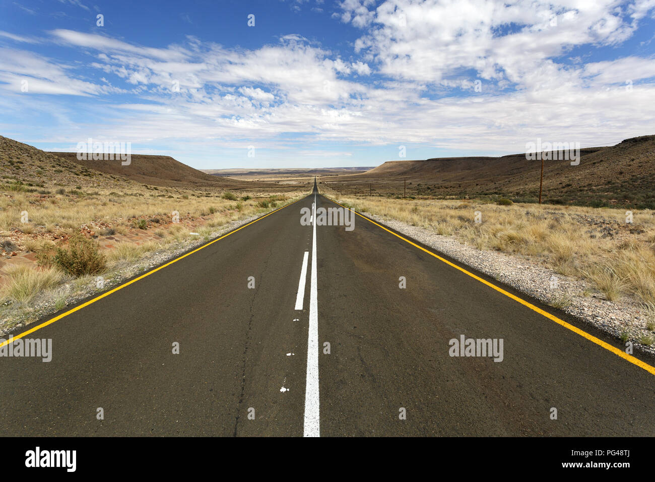 Long stretch of straight blacktop highway through the Namibian Desert ...