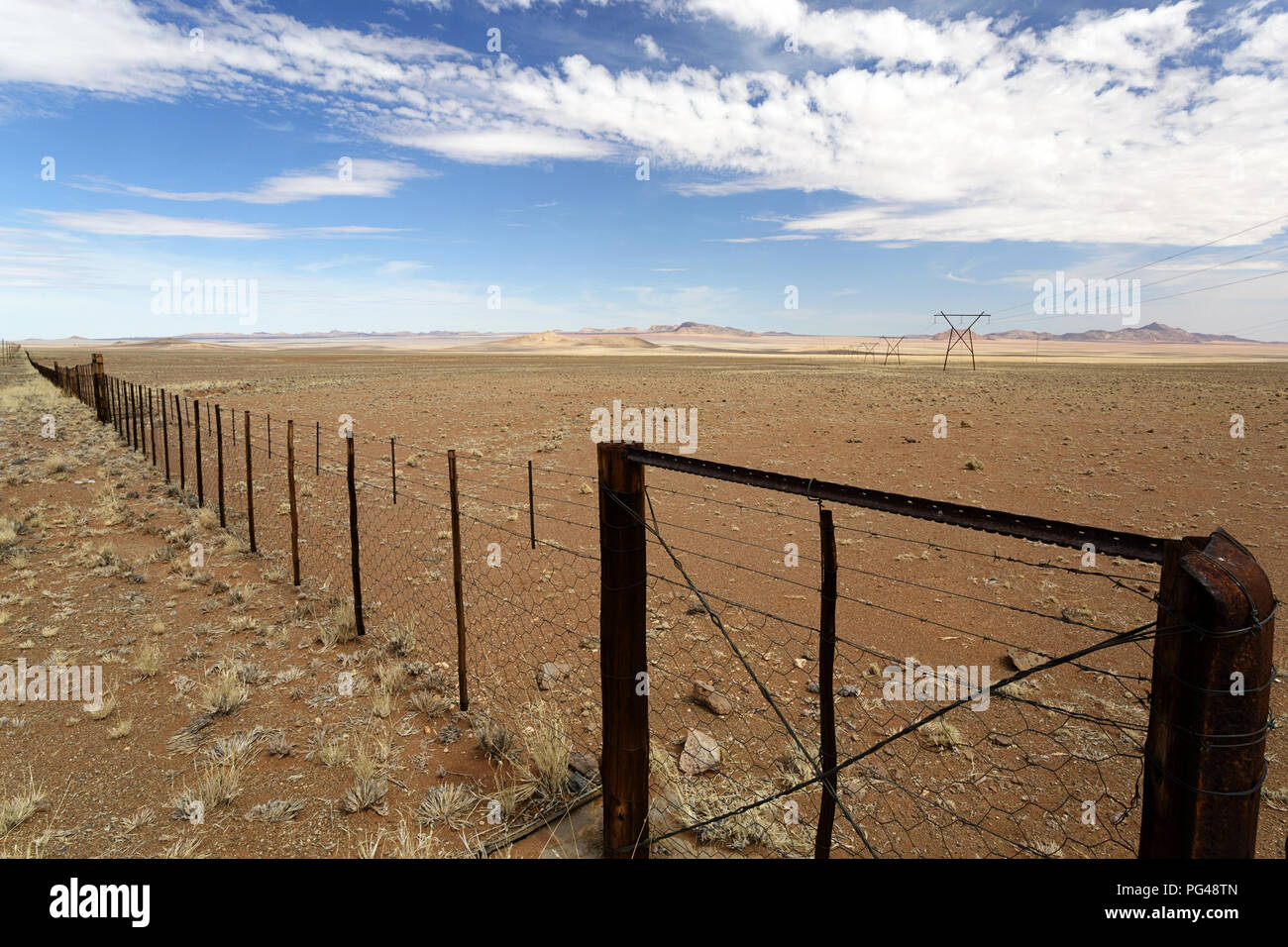Iron fence and a gate of an rural african ranch in desert landscape ...